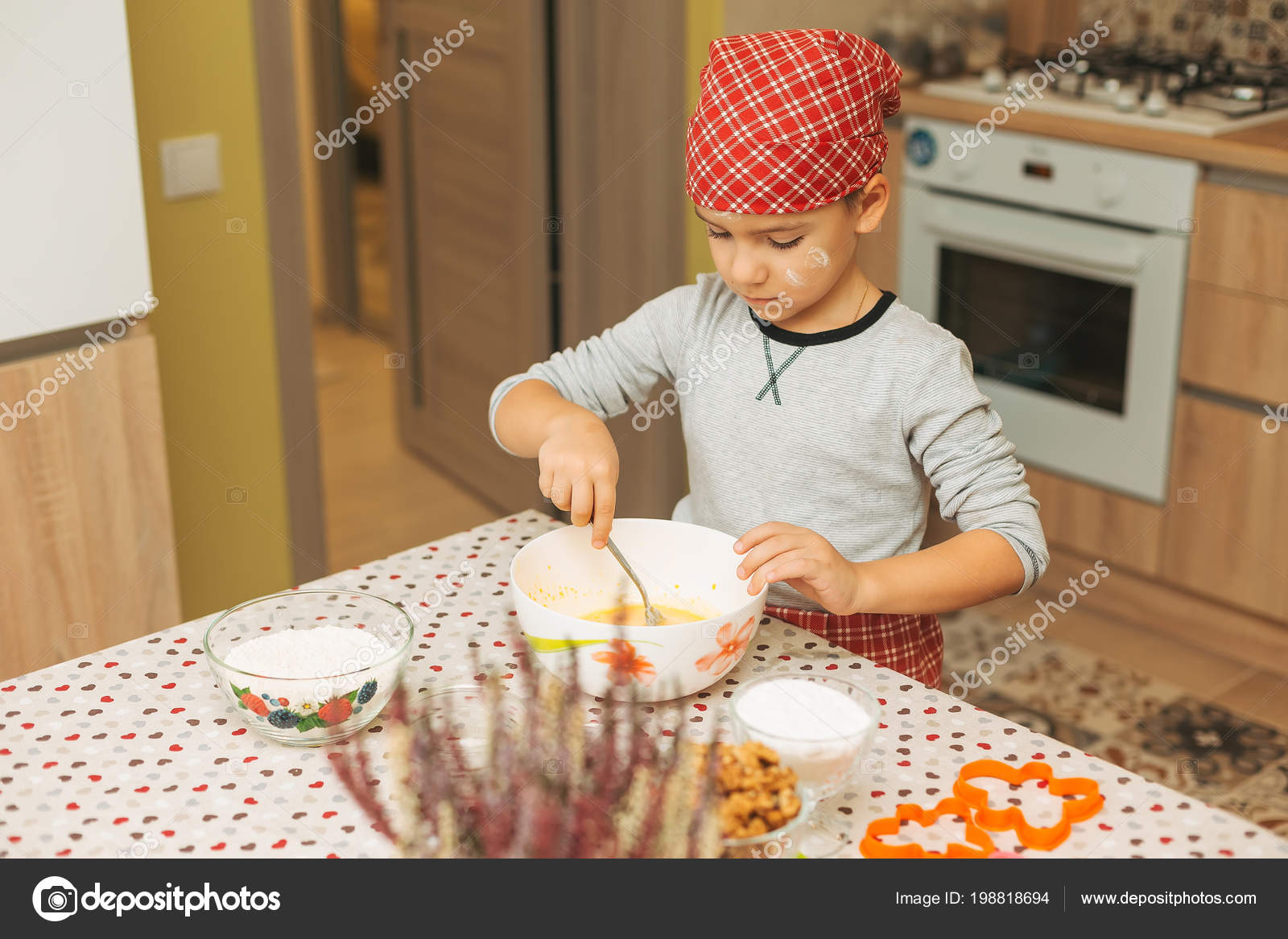 Cute boy cooking in kitchen at home Stock Photo by ©diignat 198818694