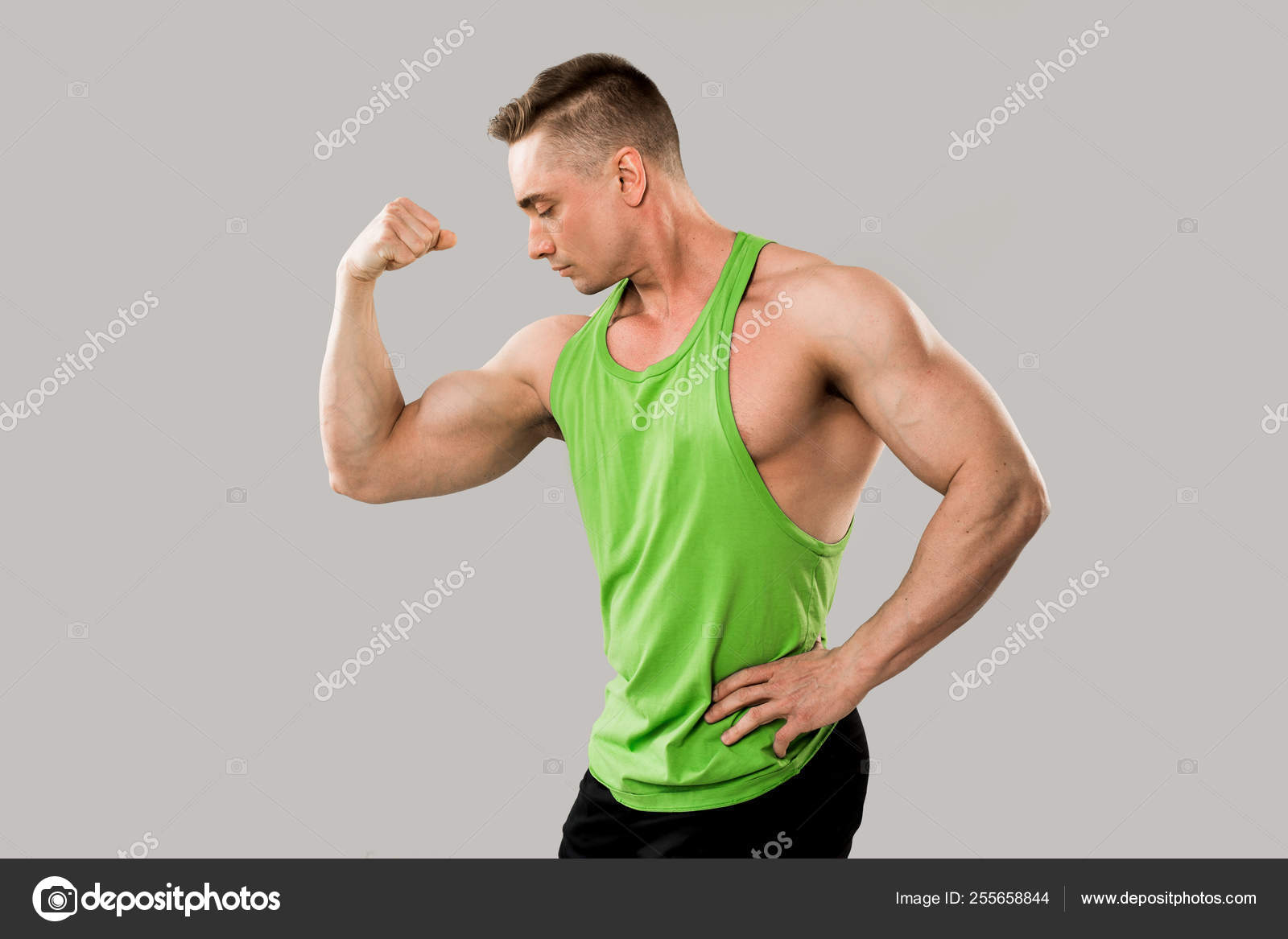 Handsome Athletic Man Muscles Green Vest — Stock Photo © Zoom01 #255658844