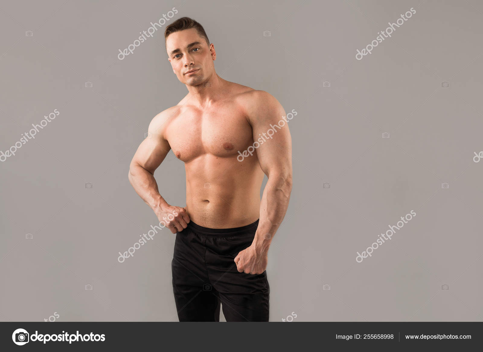 Handsome Man Muscles Gray Background Stock Photo by ©Zoom01 255658998