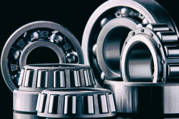 Close-up of a set of ball and roller bearings for repair lying on the ...