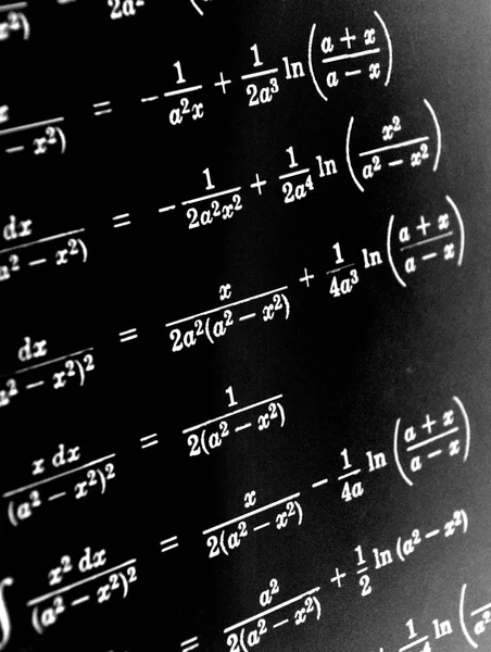 Large number of mathematical formulas on a black background - Stock ...