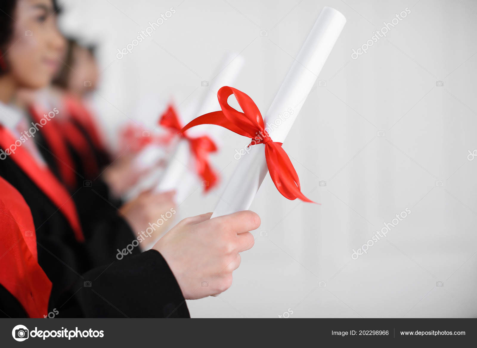 Students in bachelor robes with diplomas indoors. Graduation day Stock ...