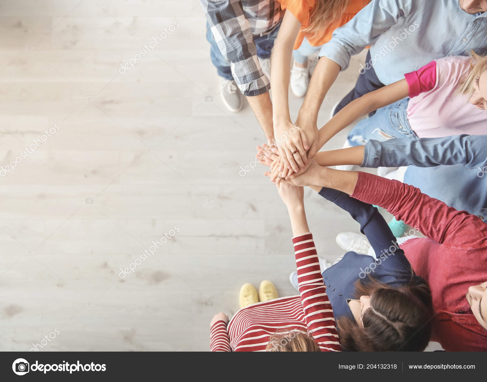 Young people putting hands together indoors. Unity concept Stock Photo ...