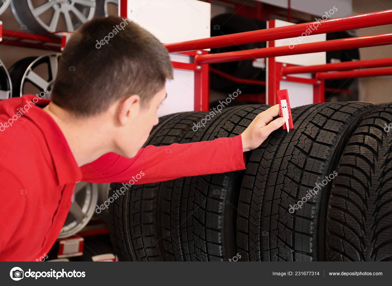 Young Mechanic Car Tires Store Stock Photo by ©belchonock 231677314