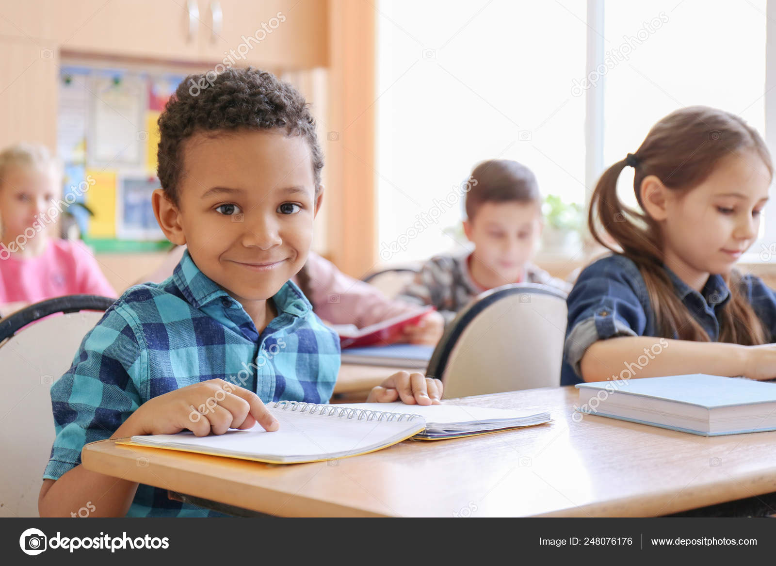 Cute children doing homework in classroom at school — Stock Photo ...