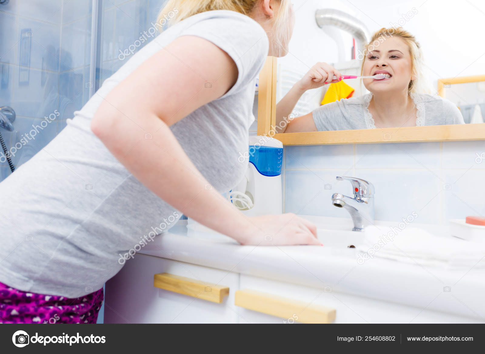 Woman brushing cleaning teeth in bathroom Stock Photo by ©Anetlanda ...