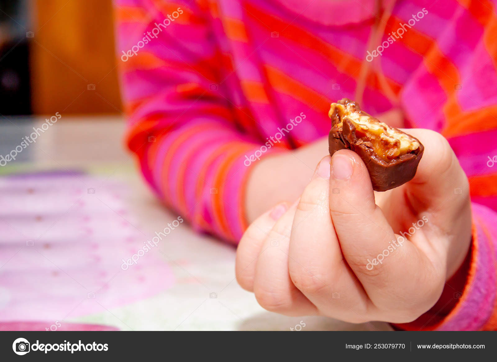 Little girl eating Snickers chocolate bar for breakfast Stock Photo by ...