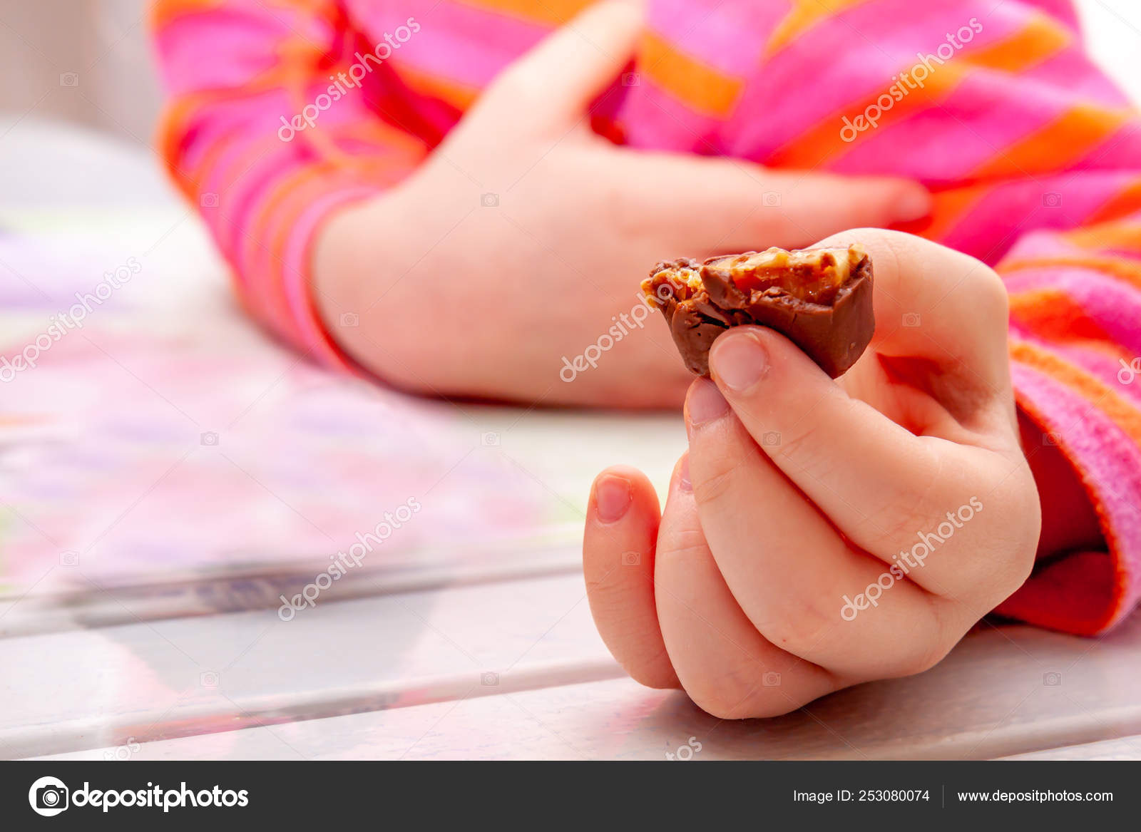 Little girl eating Snickers chocolate bar for breakfast — Stock Photo ...