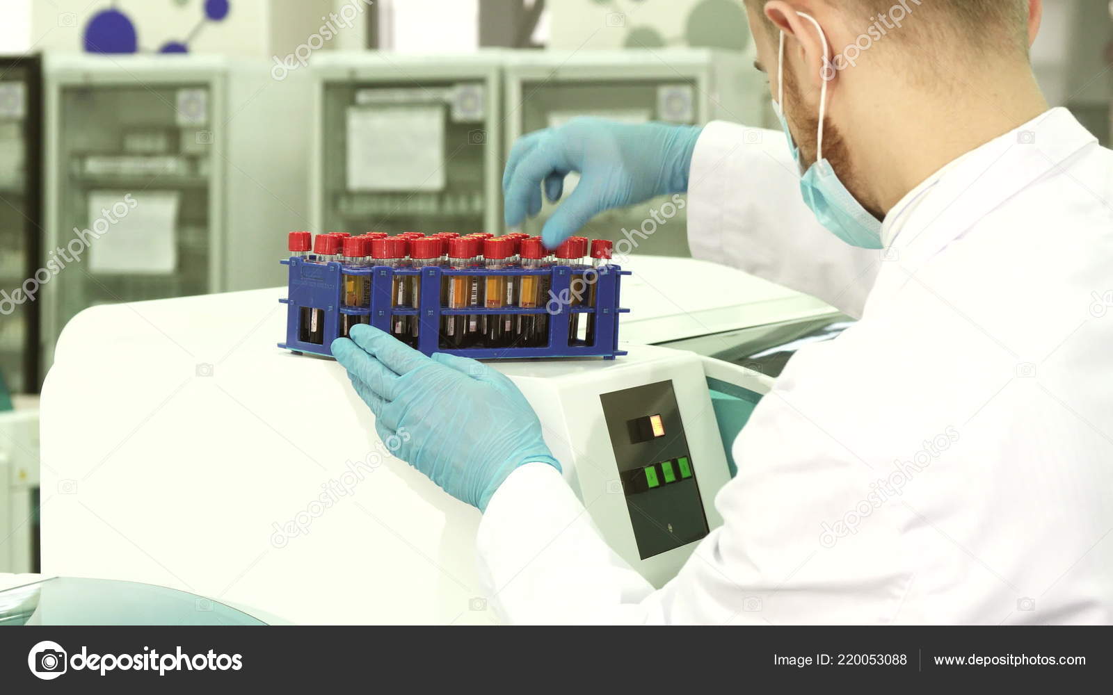 A professional lab technician checks each of the tubes before loading ...