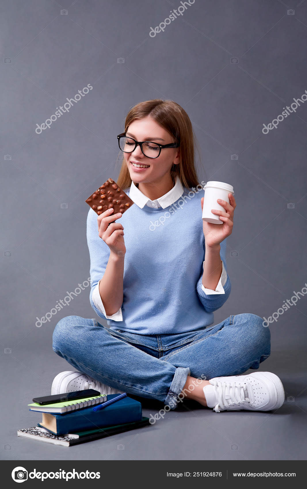 Student eating chocolate bar and drinking coffee. Student concept ...