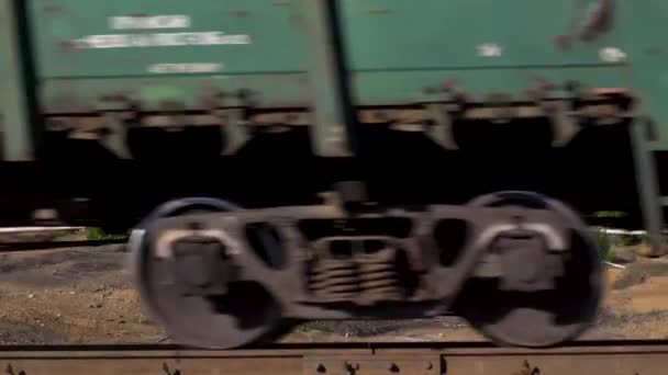 Side view of a freight train moving on rails with beautiful natural ...