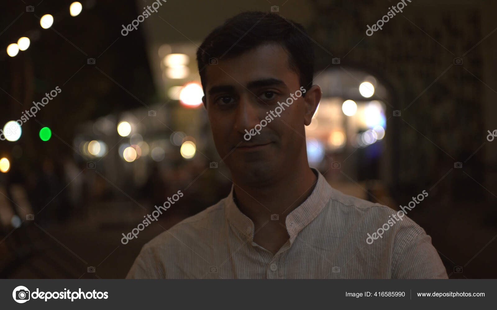 Handsome smiling man winking at someone in front of the camera. Media ...