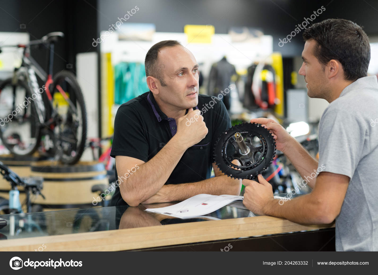Customer holding bicycle cog at shop counter — Stock Photo ...