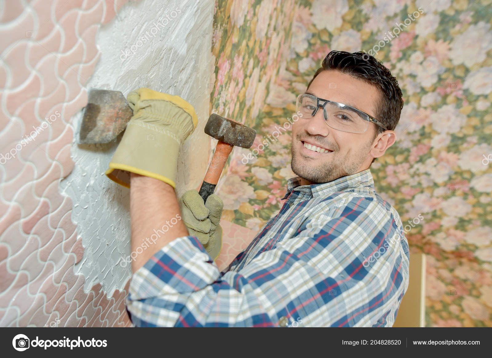 Chiselling old motif off a wall Stock Photo by ©photography33 204828520