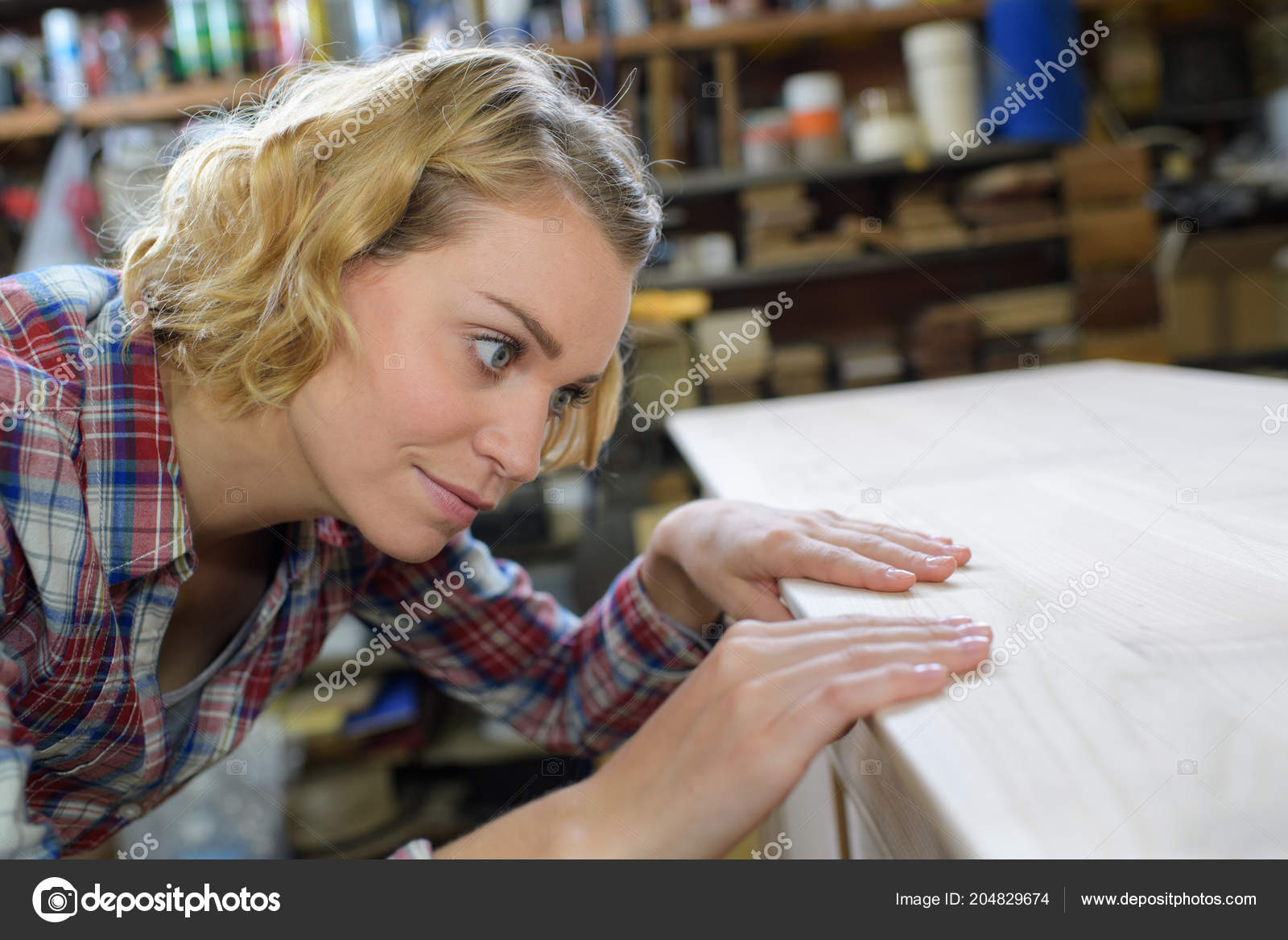 Woman craftsperson working on workbench in workshop Stock Photo by ...