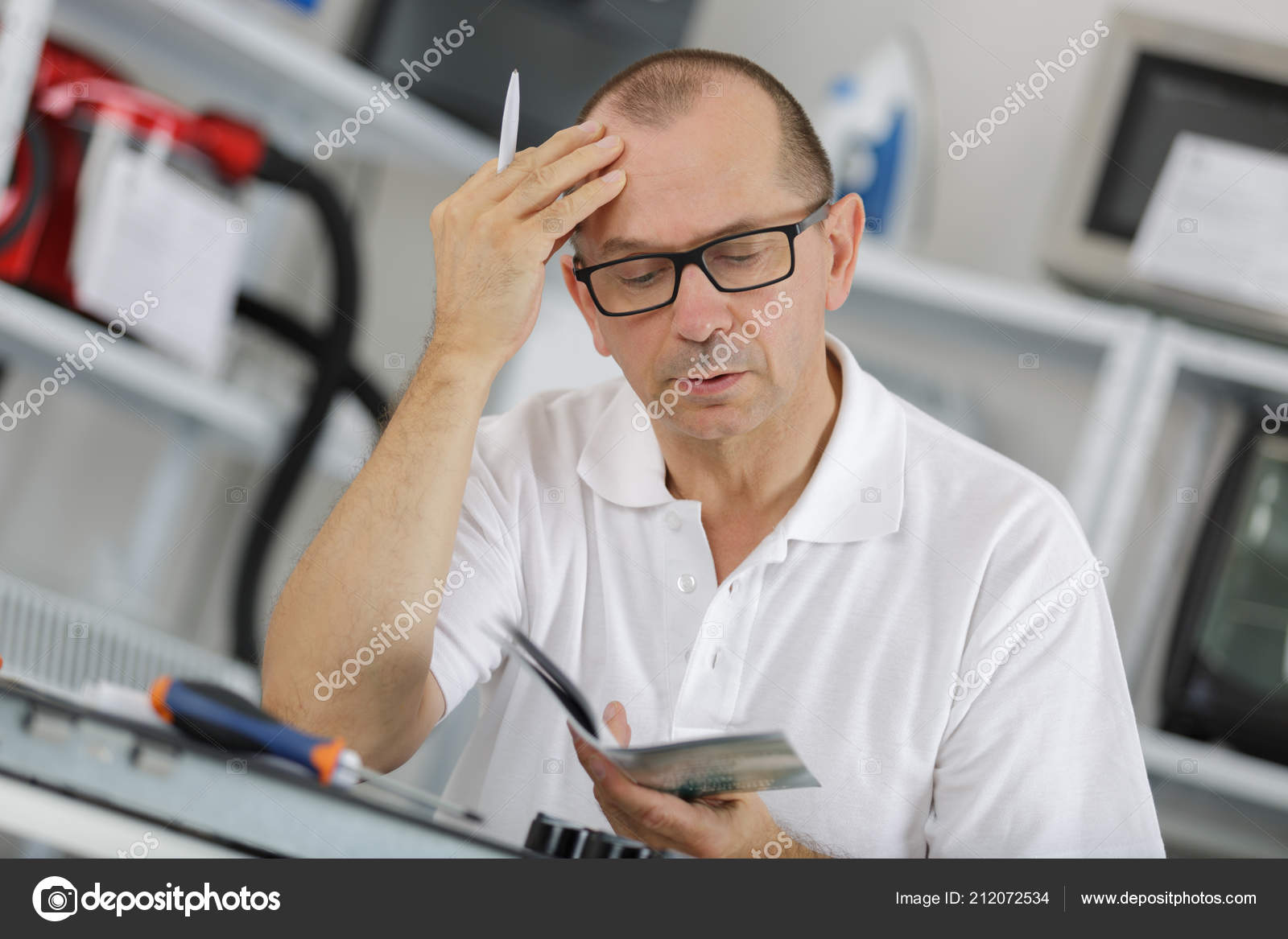 Repairman Reading Technical Manual Stock Photo by ©photography33 212072534