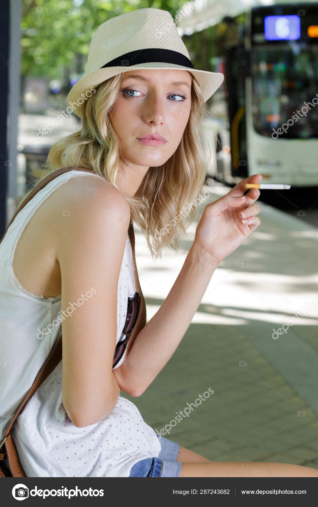 Woman smoking on the bus stop Stock Photo by ©photography33 287243682