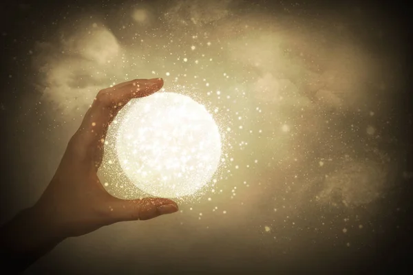 A magic ball in the hands of the universe. magic particles, glow ...