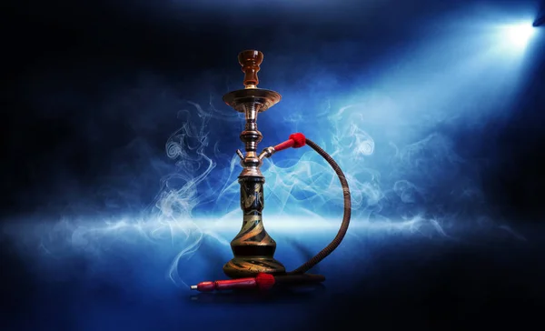 Hookah smoking on a concrete background, illuminated by the spotlight ...