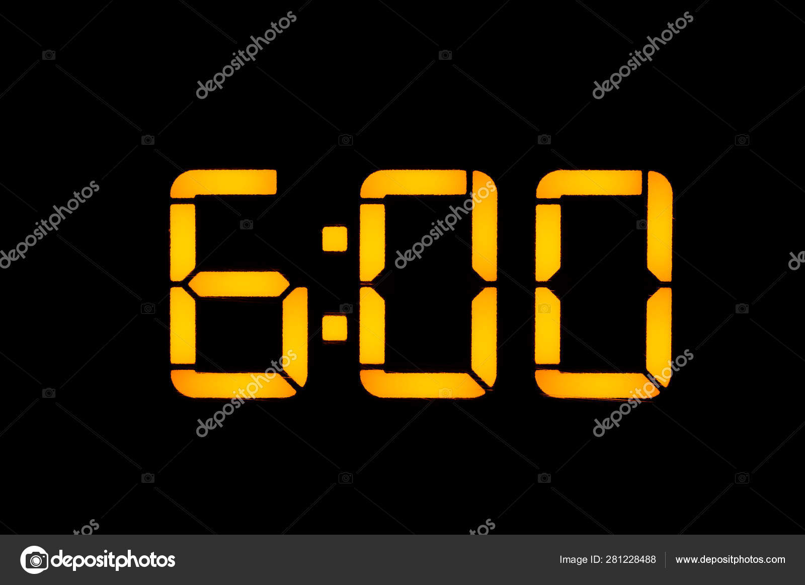 Electronic digital clock with yellow numbers on a black backgrou ...