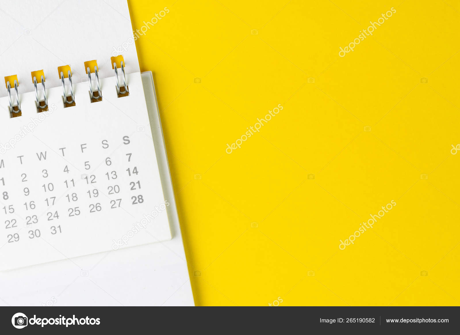 White clean calendar on solid yellow background with copy space ...