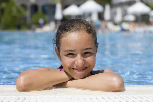 Beautiful Teenage Girl Purple Swimsuit Sitting Poolside Smiling Camera