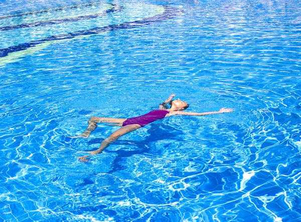 Beautiful Teenage Girl Purple Swimsuit Sitting Poolside Smiling Camera