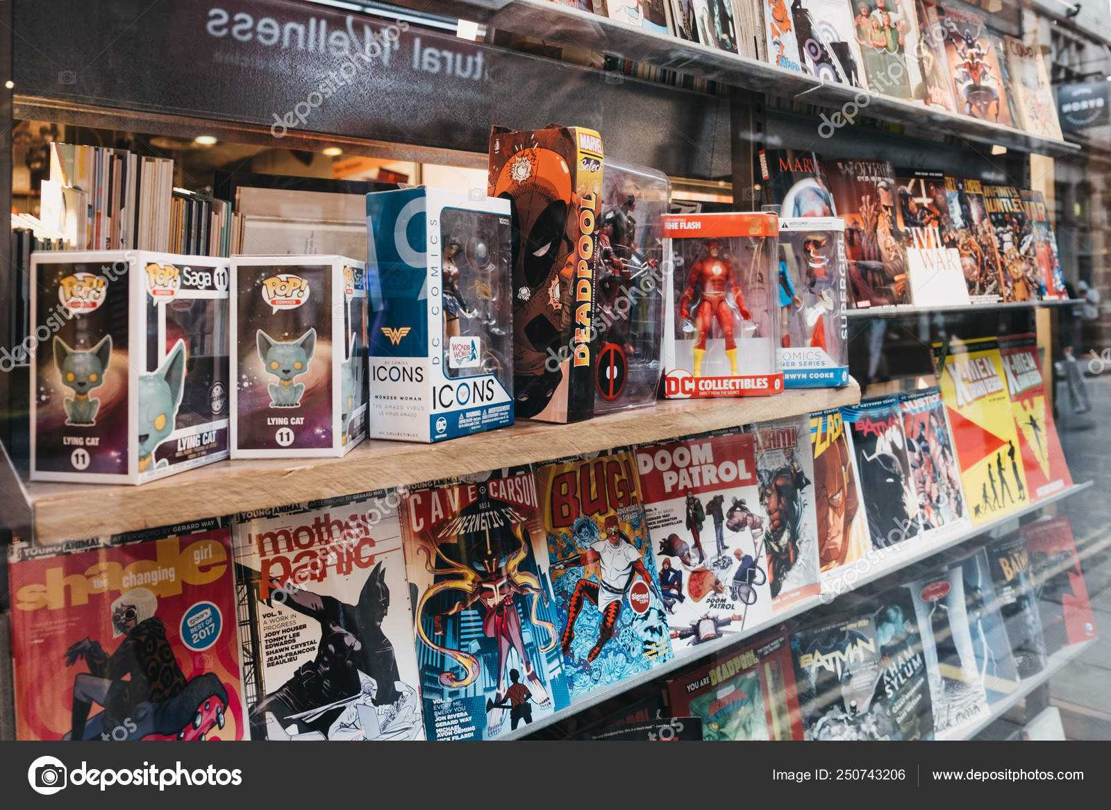 Comic books on a window retail display of Gosh! Comics shop in C ...