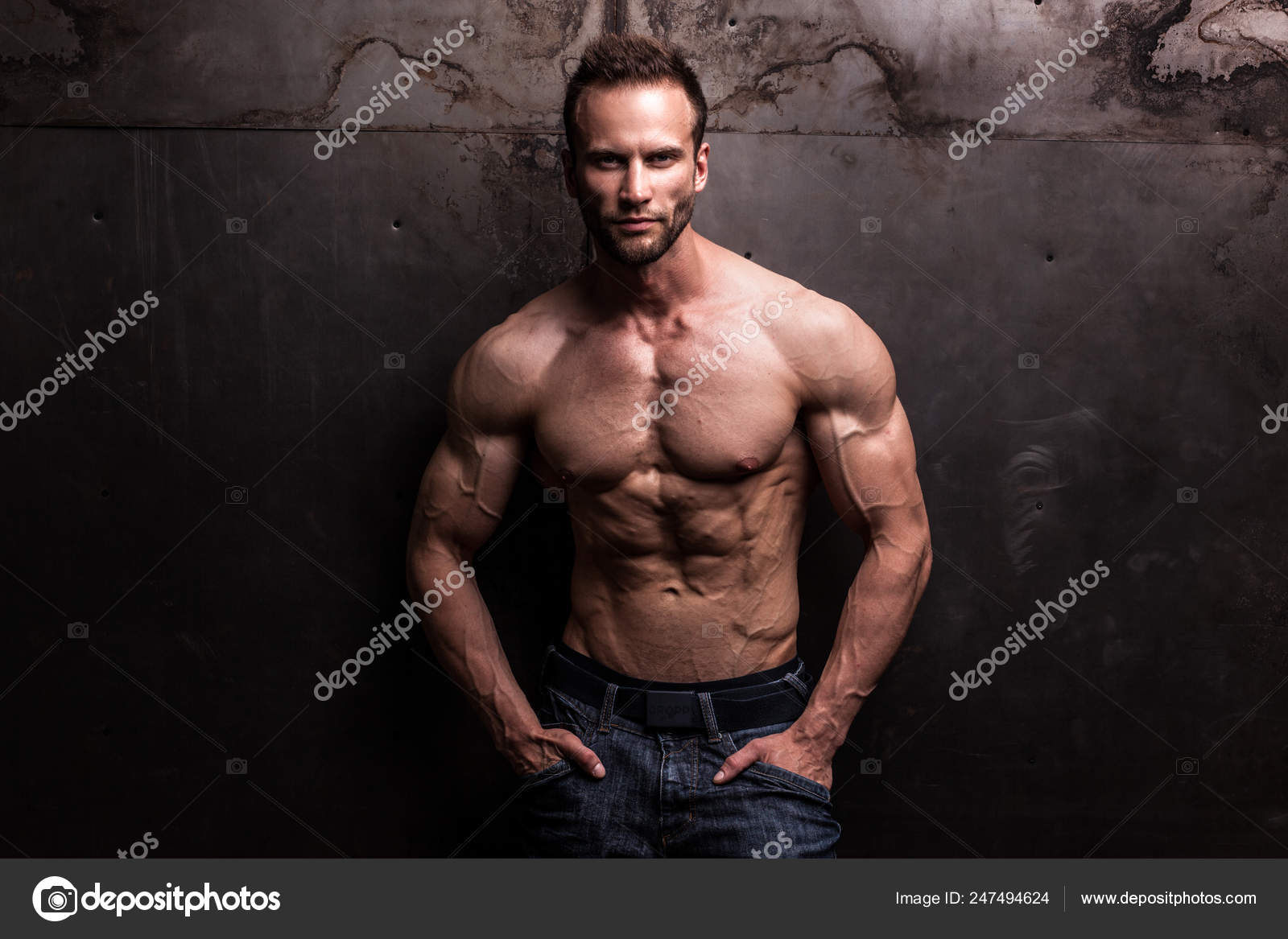 Strong athletic man on dark grunge background — Stock Photo © doodko ...