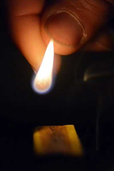 Igniting a match in the dark on a matchbox - Close-up of a lighting ...