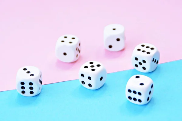 Two dice with opposite color play - one dice is blue and stands on pink ...
