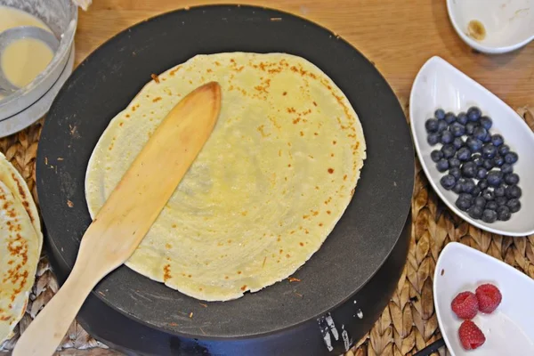 Homemade crepes in closeup with topics on a crepe iron - Fresh and ...