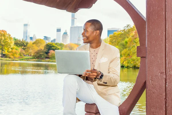 Business Man Working. Dressing in cream blazer, collarless sweater ...