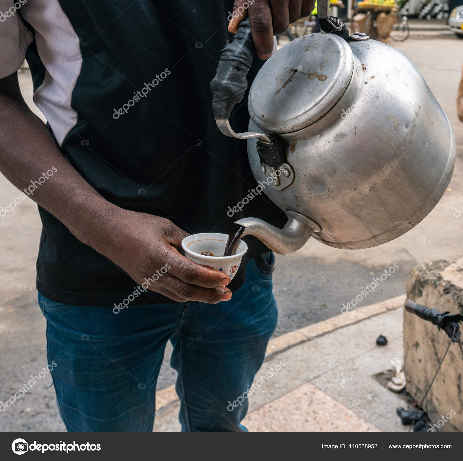 Black African Man Pouring Coffee in a Small cup Pial on the street in ...