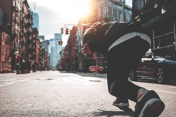 Athlete man in running start pose on urban street. Male runner ...