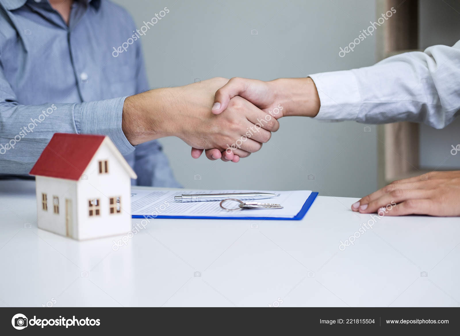 Real Estate Agent Customers Shaking Hands Together Celebrating Finished ...