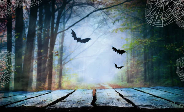 empty wooden table with creepy Halloween background - Stock Image ...