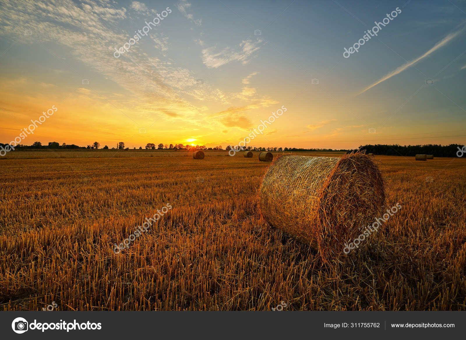 Beautiful summer sunset over fields with hay bales — Stock Photo ...