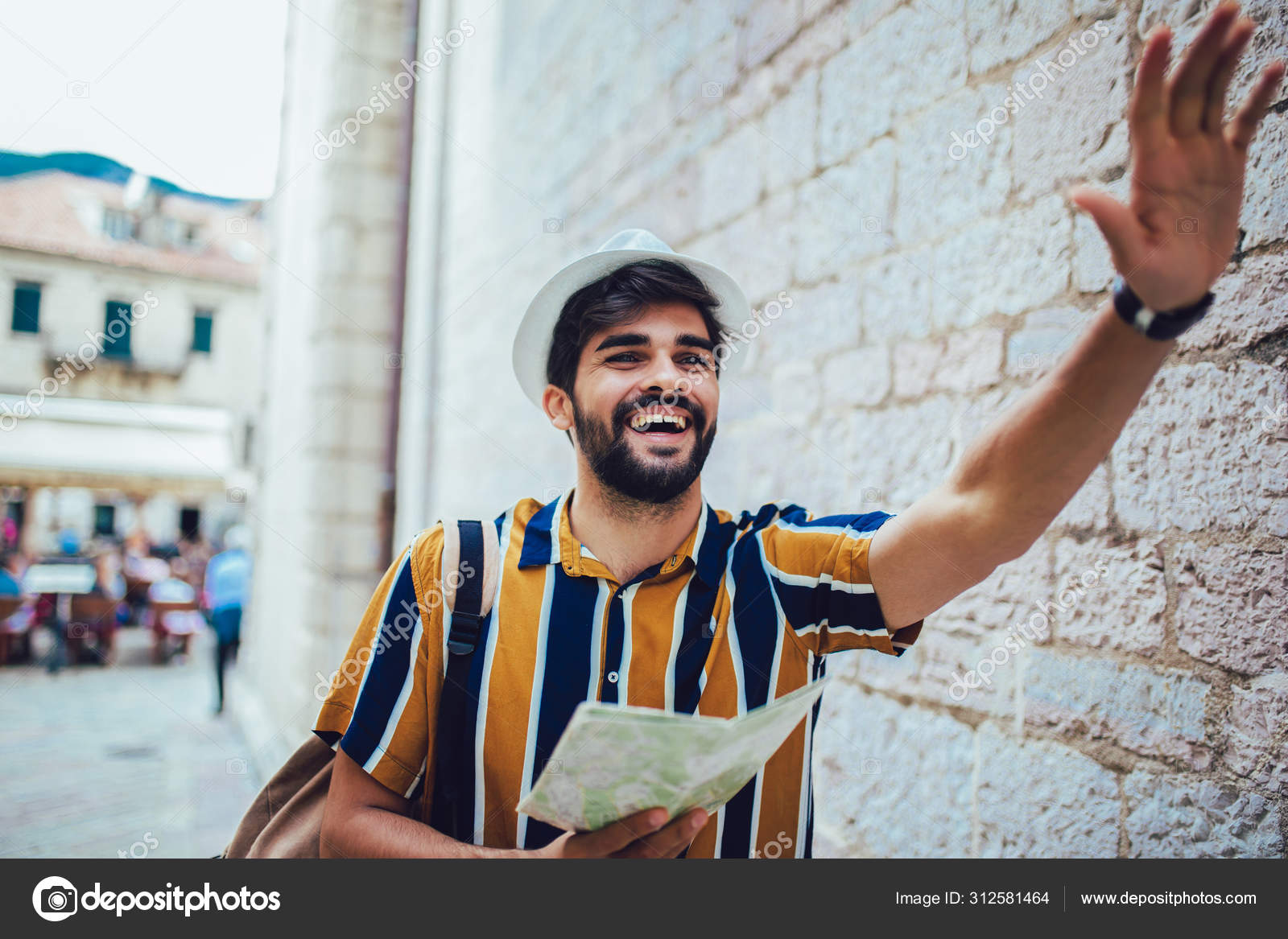 Handsome bearded tourist with backpack is making travel across c ...