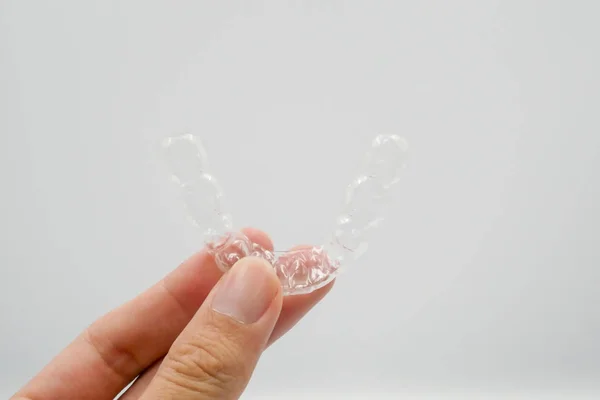 Hand holding clear plastic retainer teeth Stock Photo by ©Bhubeth ...