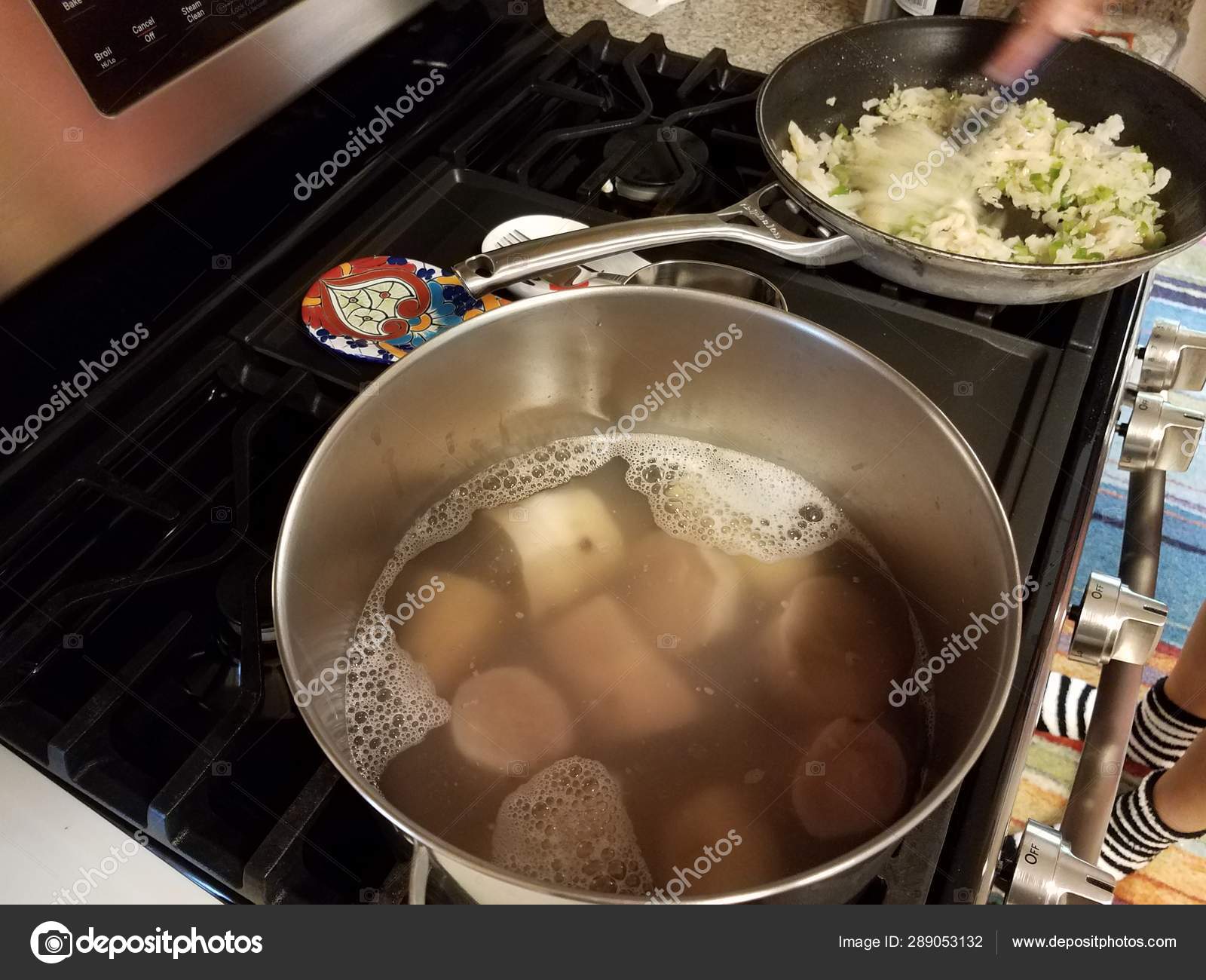 Woman cooking traditional Puerto Rican food of codfish and root ...