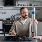 Handsome Engineer Holding Rocket Model Home Looking Away Stock Photo by ...
