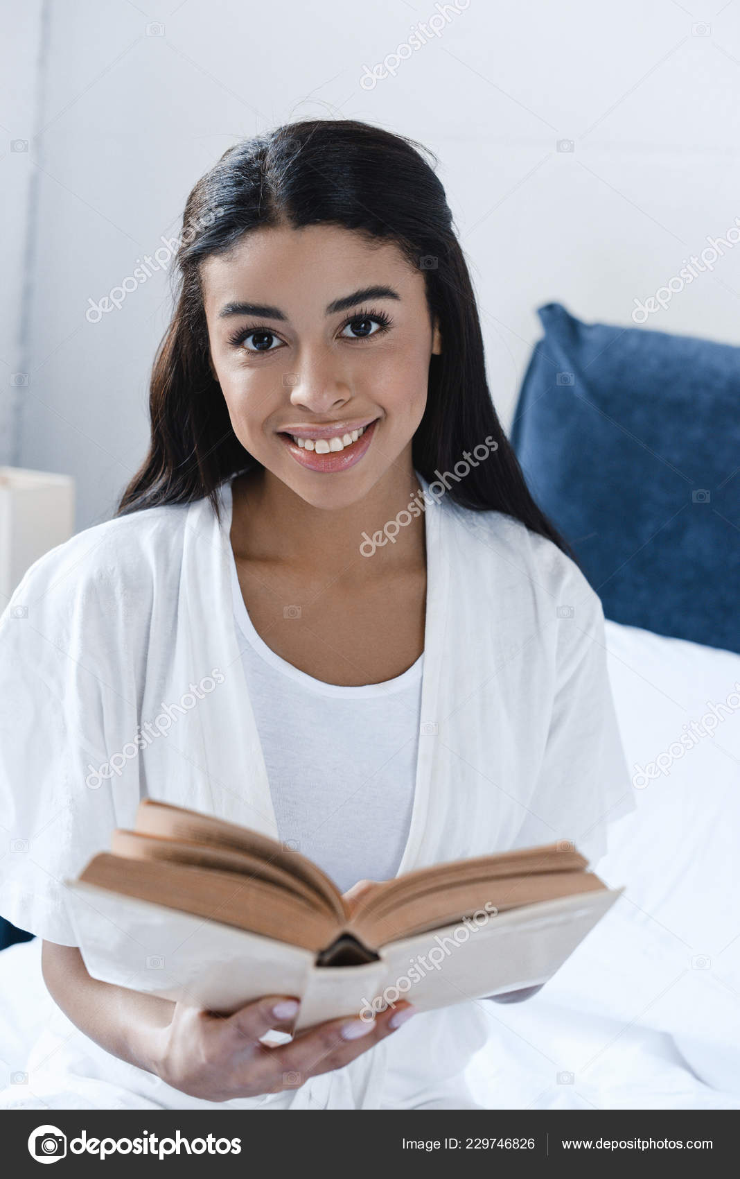 Smiling Beautiful Mixed Race Girl White Robe Holding Book Bed — Free