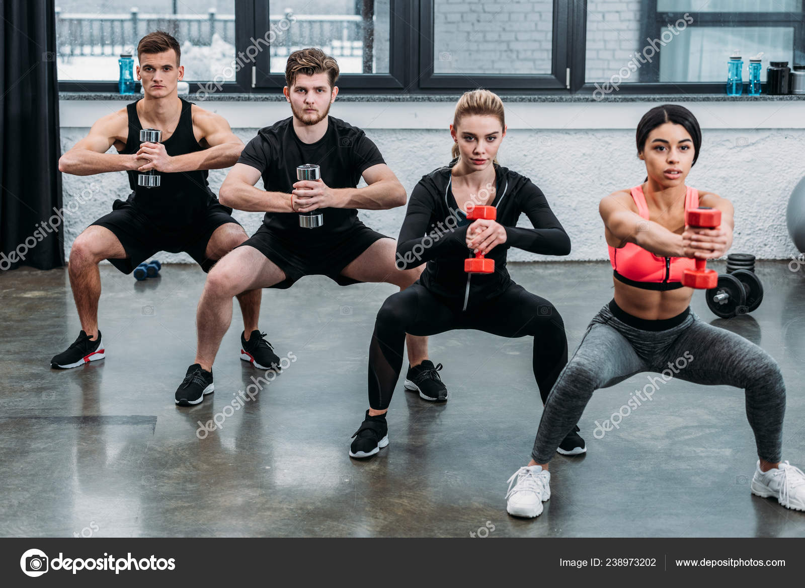 Athletic Young Men Women Exercising Dumbbells Looking Camera Gym ...