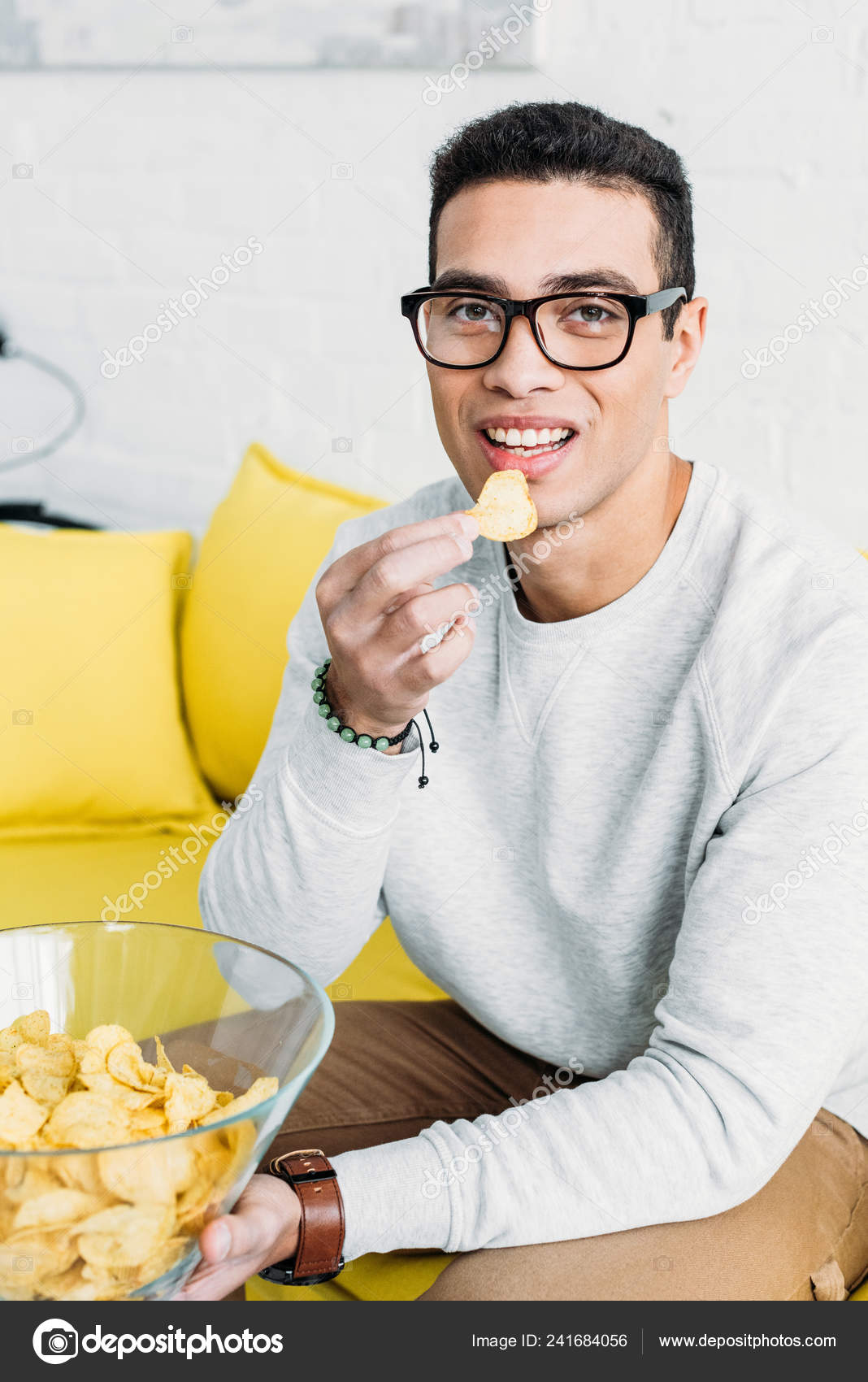 Handsome Young Mixed Race Man Sitting Yellow Sofa Eating Chips — Stock ... Handsome Young Mixed Race Man Sitting Yellow Sofa Eating Chips — Stock ...