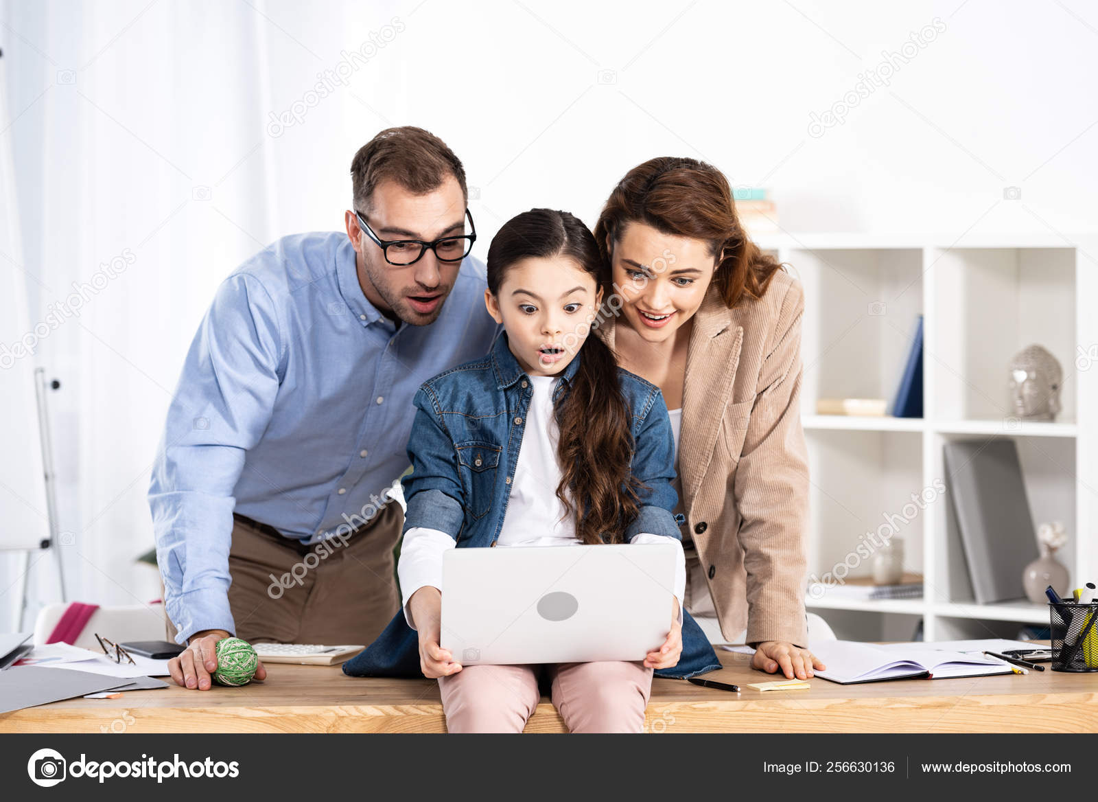 Surprised Parents Looking Laptop Daughter Office Stock Photo by ...