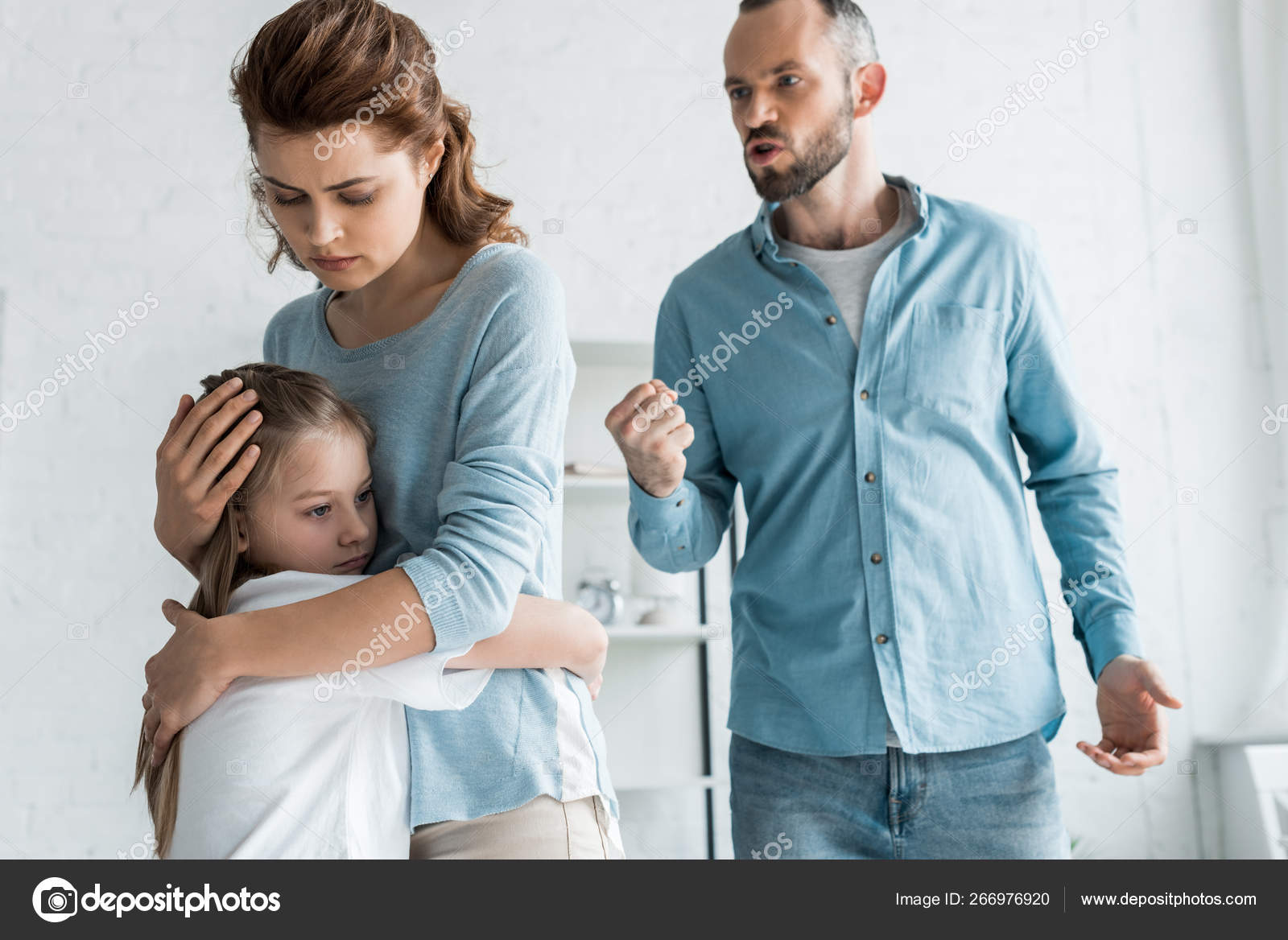 Upset Mother Hugging Daughter While Angry Man Showing Fist Home — Stock ...