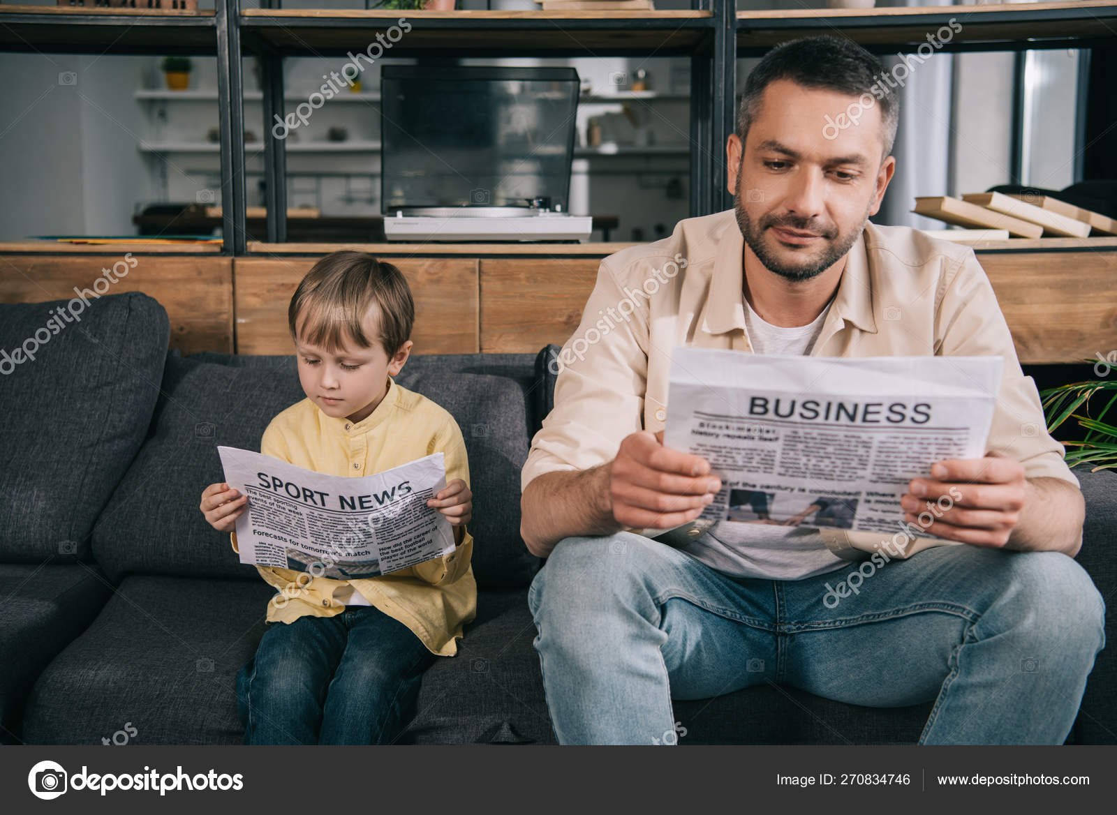 Concentrated Father Son Reading Newspapers While Sitting Sofa Home ...