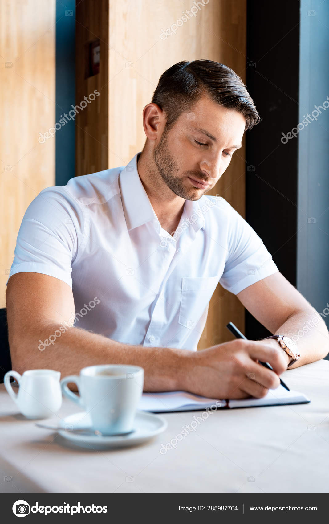 Focused Handsome Man Writing Textbook Cafe Stock Photo by ©IgorVetushko ...