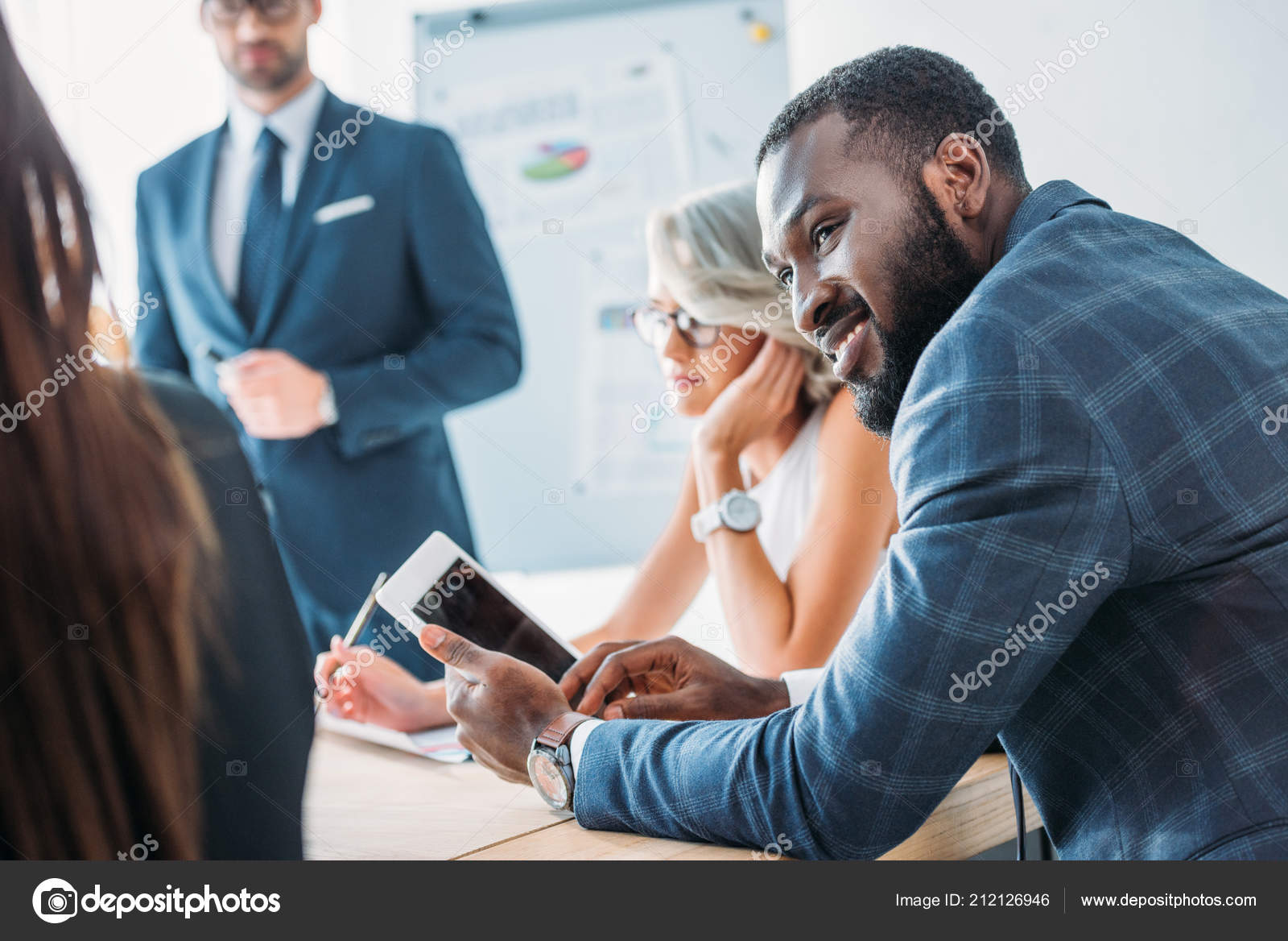 Smiling African American Businessman Holding Tablet Looking Colleague ... Smiling African American Businessman Holding Tablet Looking Colleague ...